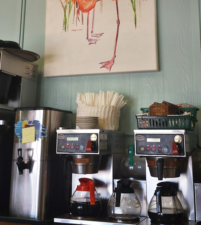 Coffee station with a flamingo painting above—because caffeine tastes better when served with a side of Florida whimsy.
