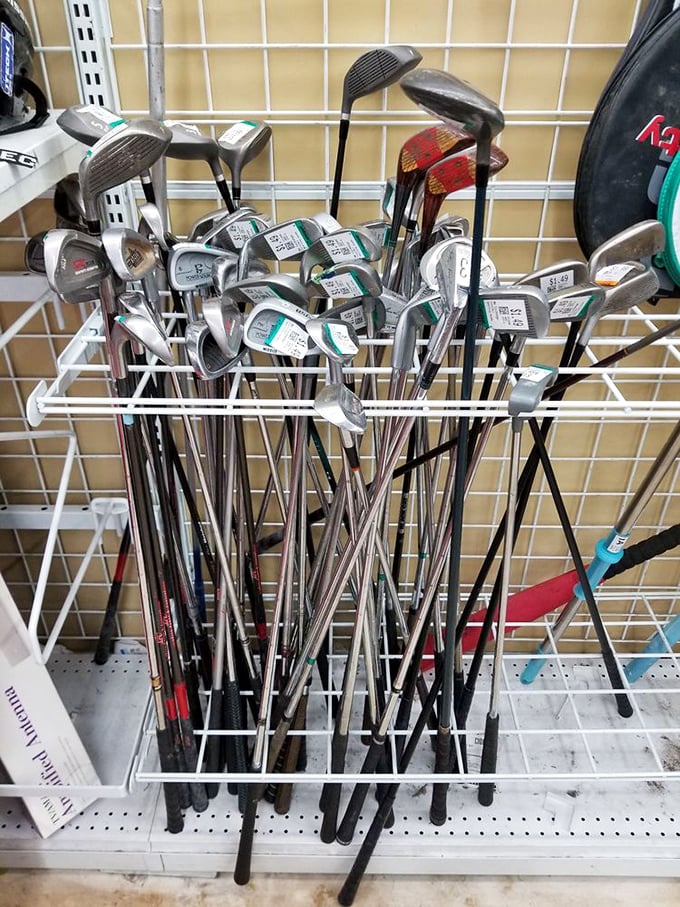 Golf clubs gathered like metallic flowers in a bouquet of sporting potential. Weekend warriors and garage decorators, your chariot awaits.