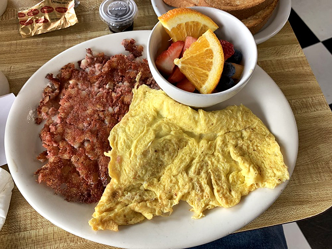 Corned beef hash with that essential crispy-to-tender ratio, paired with eggs so perfectly yellow they look Photoshopped (but aren't).
