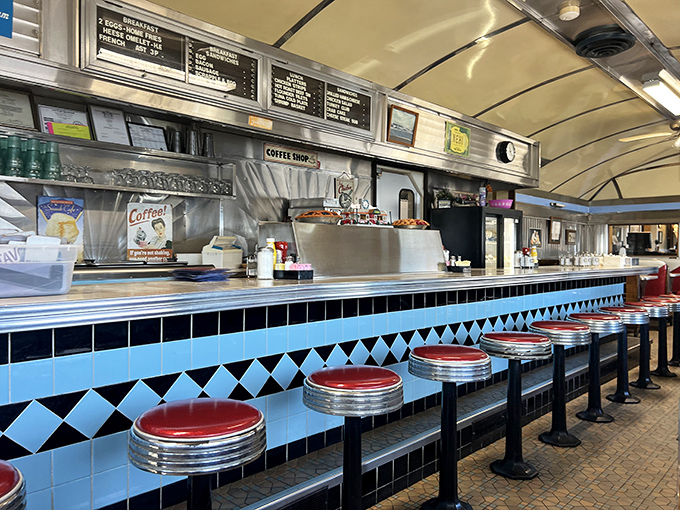 Classic diner counter seating where solo diners become temporary family. Those red stools have heard more town gossip than the local barber.
