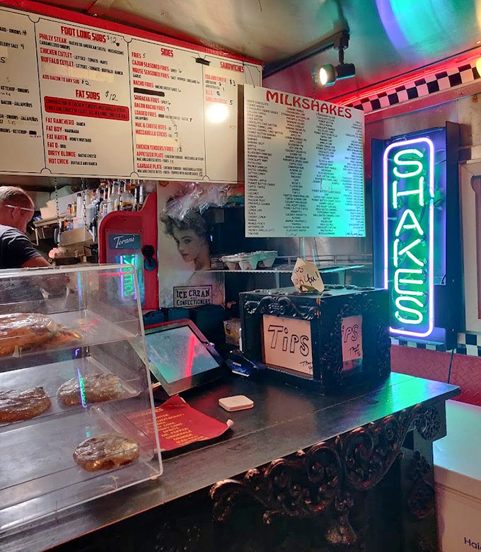Neon signs and vintage decor create the perfect backdrop for milkshake decisions that feel monumentally important after midnight.