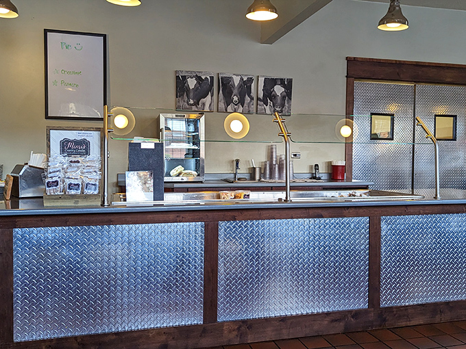 The service counter gleams with promise, a stainless steel altar where hungry pilgrims come to worship at the church of comfort food.