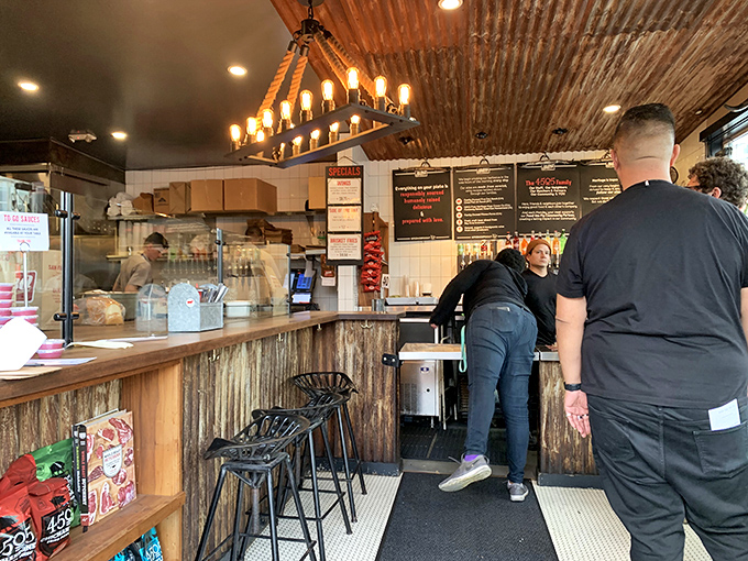 Where decisions are made and orders are placed. That corrugated metal backdrop isn't just design—it's a nod to the industrial heritage of American BBQ tradition.