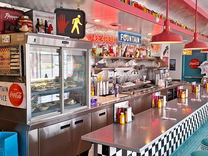 Counter seating offers front-row views to the culinary choreography that transforms simple ingredients into diner masterpieces.