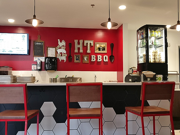 Modern meets traditional at the counter seating area – those hexagonal tiles and red chairs say "we're stylish," while the menu says "but we're all about the smoke."
