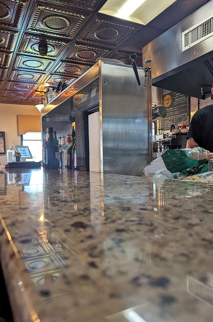 The polished bar counter reflects more than just light—it mirrors decades of conversations, celebrations, and first-time visitors becoming regulars.