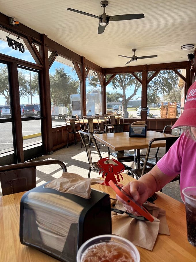 The screened patio offers a bright, airy dining option where even the plastic crabs seem happy to join you for lunch.