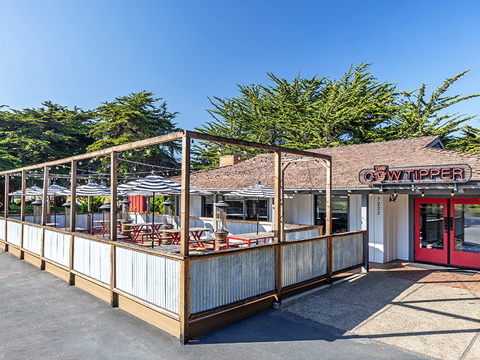 The Cow Tipper's outdoor patio beckons with its casual coastal vibe, promising good times and better burgers just steps from the Pacific.