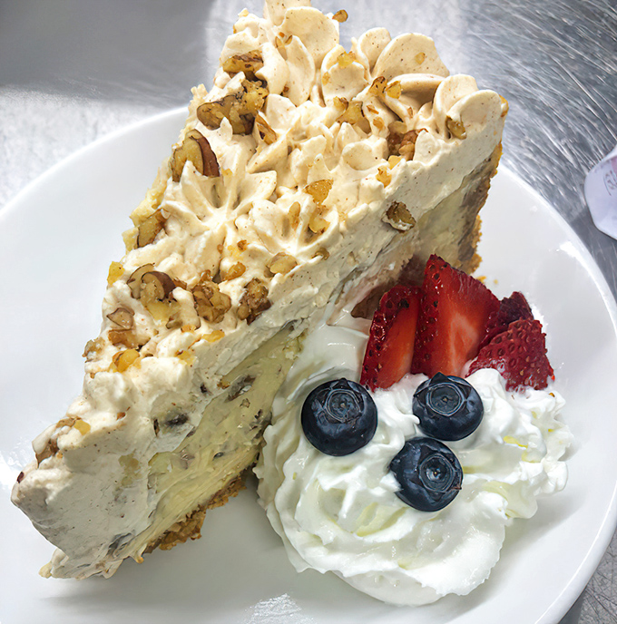 This isn't just dessert, it's architecture &ndash; layers of cream, cake, and nuts creating a masterpiece that makes calorie-counting seem like a crime against joy.