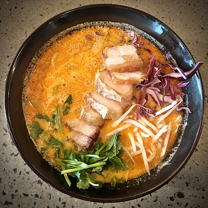 This Crispy Pork Belly Soup is basically a warm hug in bowl form&mdash;rich coconut curry broth cradling crispy pork that defies culinary physics.