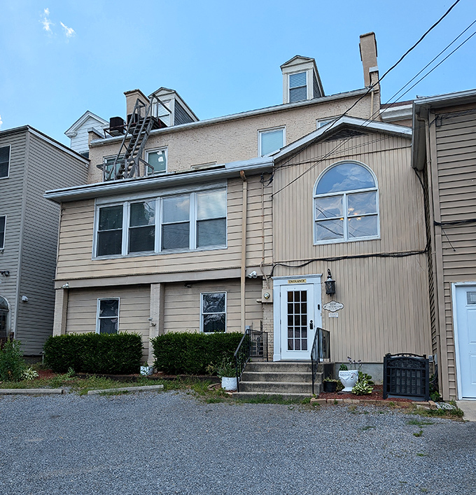 This modest multi-family home represents Cumberland's affordable housing market, where your retirement dollars stretch like yoga instructors.