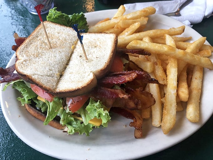 This BLT deluxe towers with crispy bacon and fresh vegetables on perfectly toasted bread.