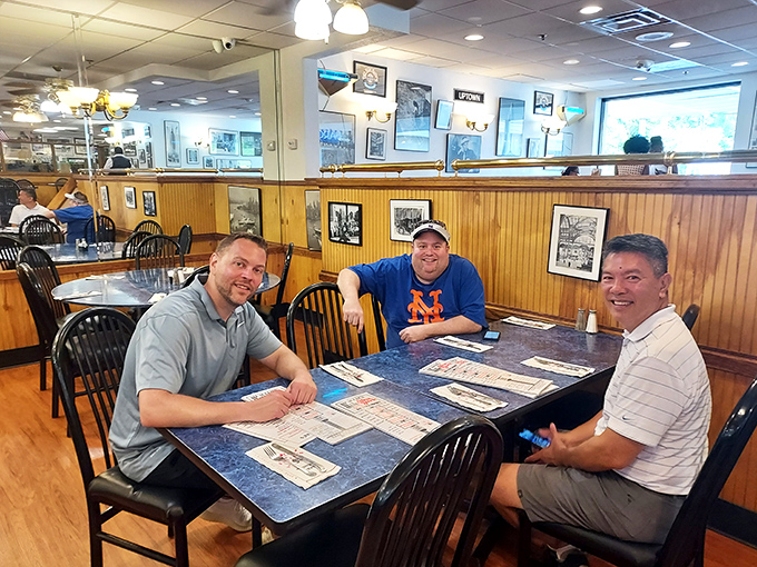 Happy diners plotting their strategic approach to the menu &ndash; notice the look of both determination and joy in their pre-sandwich planning session.