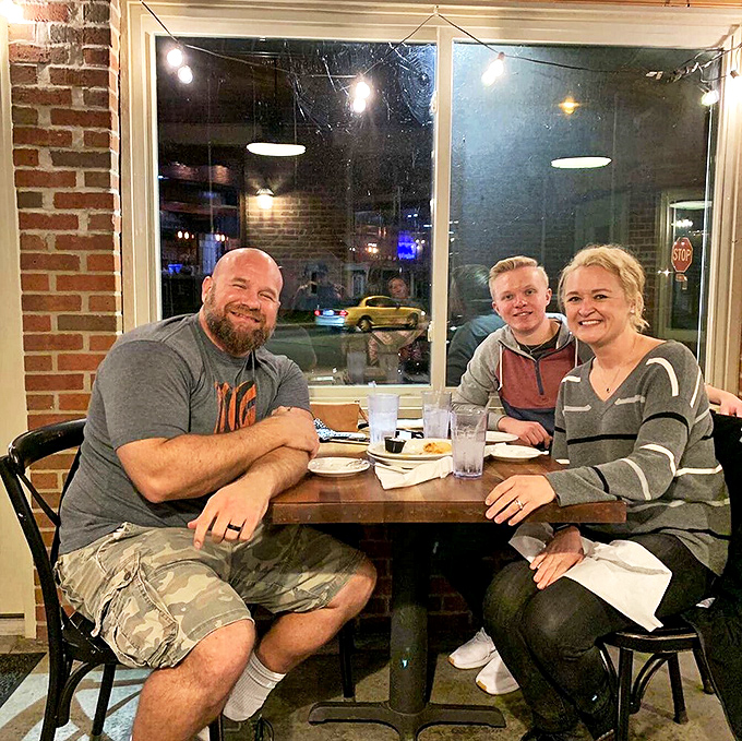 Happy diners by the window&mdash;living proof that good barbecue creates its own special kind of contentment that's impossible to fake.