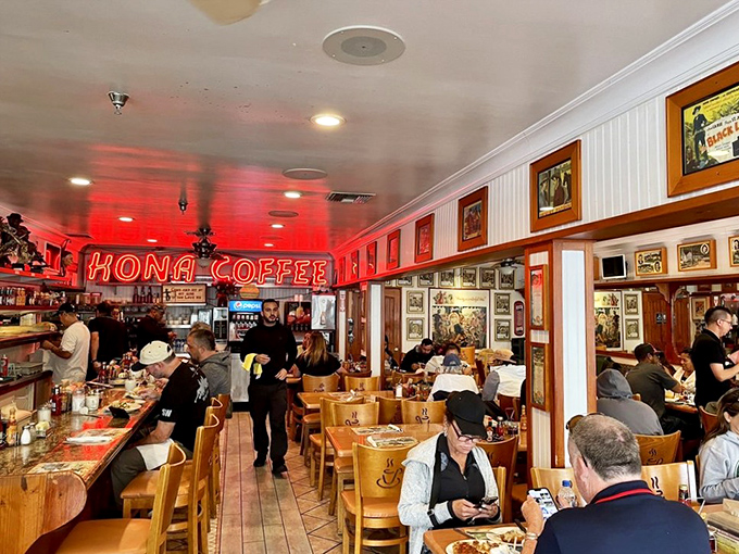 The bustling counter beneath the glow of "KONA COFFEE" neon&mdash;where locals and visitors alike gather for morning fuel before island adventures.