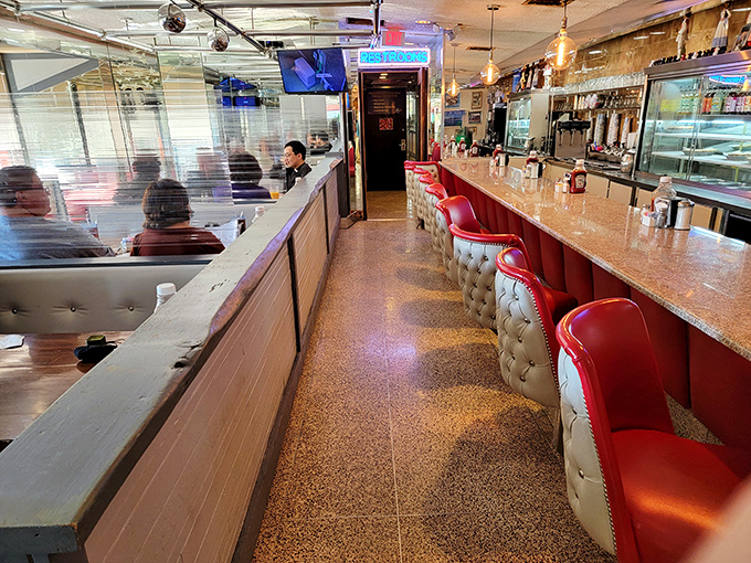 The diner's interior corridor&mdash;where the red stools stand like loyal soldiers, ready to support you through thick and thin (mostly thick after eating here).