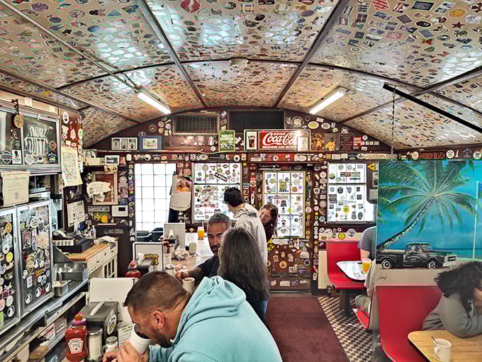The narrow dining car layout creates an intimate experience where conversations flow between booths and counter seats like the endless coffee.