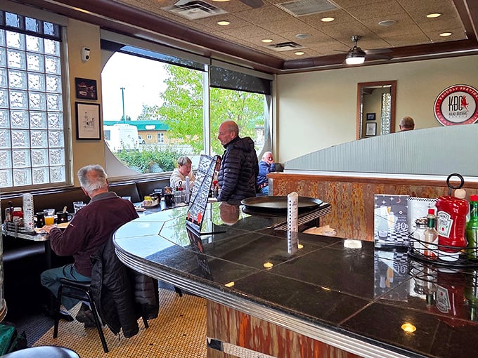 The counter seating&mdash;where strangers become temporary neighbors, united by the universal language of "pass the ketchup, please."