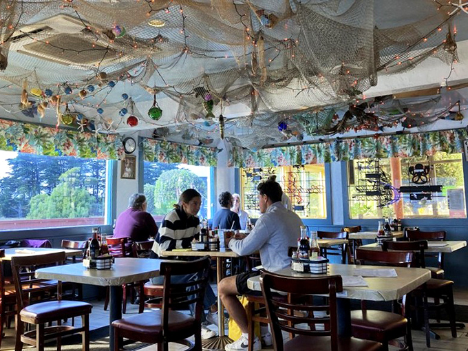 Conversations flow as freely as the wine at these tables. The fishing nets above aren't just decor&mdash;they're catching memories.