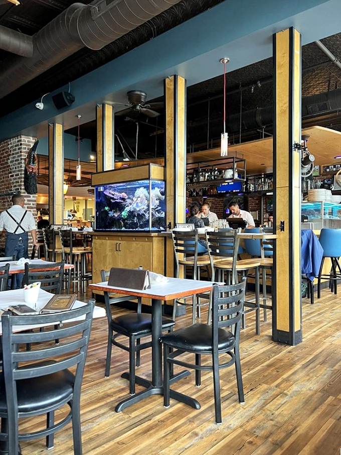 Wooden beams, brick walls, and an aquarium create the perfect backdrop for seafood adventures—like dining in a stylish submarine with better service.