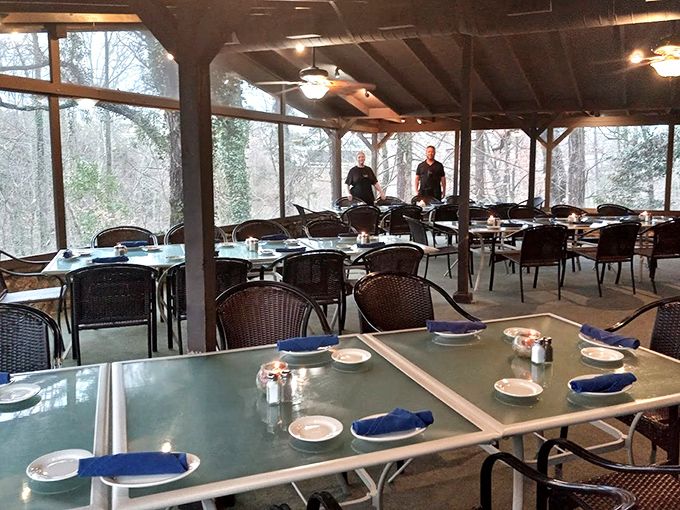 The screened dining patio brings the forest inside, offering a front-row seat to nature's show while you feast.