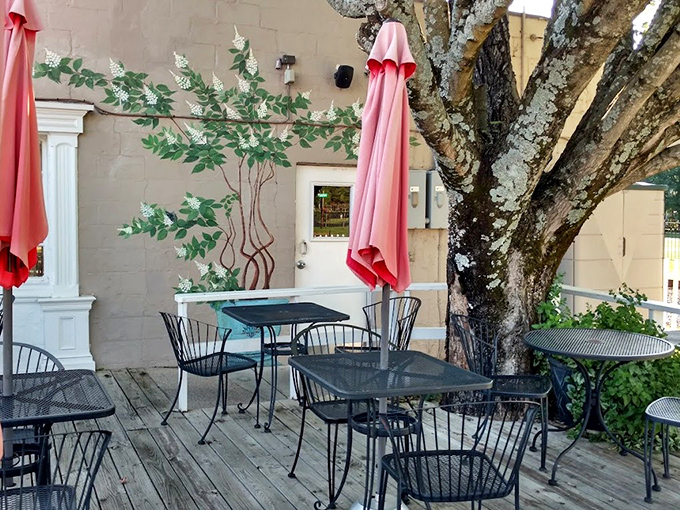 The outdoor patio offers al fresco dining under pink umbrellas and a magnificent old tree. Southern summers were made for evenings like this.