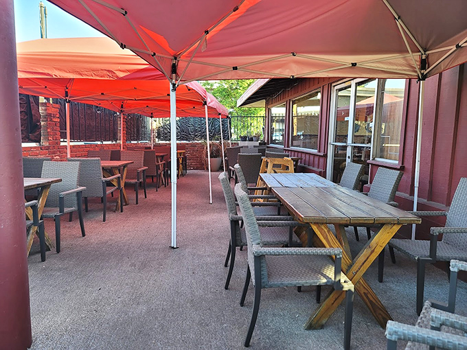 The outdoor patio—where California sunshine meets Missouri smoke. These tables have hosted countless summer evenings and sauce-stained conversations.