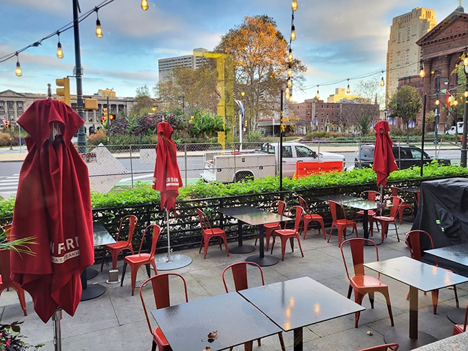 Al fresco dining with a view of Logan Square &ndash; where red umbrellas stand at attention, ready to shield your perfect meal from anything but pleasure.
