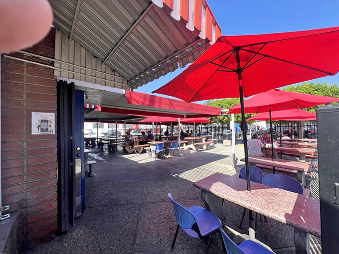The outdoor patio, with its cherry-red umbrellas, transforms a concrete corner of downtown into an urban seafood picnic where strangers become fellow food enthusiasts.