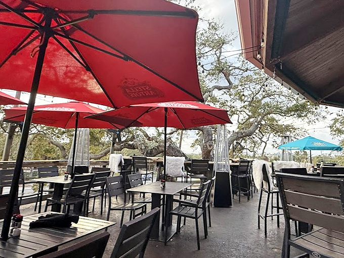 Red umbrellas dot the deck like exclamation points, emphasizing that outdoor dining here is definitely worth shouting about.