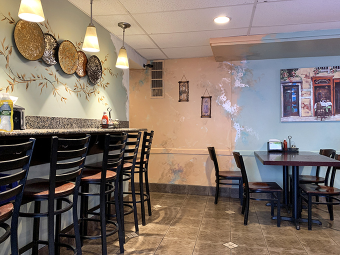 Soft blue walls adorned with decorative plates create a homey atmosphere. The kind of place where calories don't count and diet plans go to die.