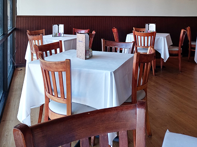 White tablecloths signal "we care about details" while wooden chairs whisper "but we're not stuffy about it."