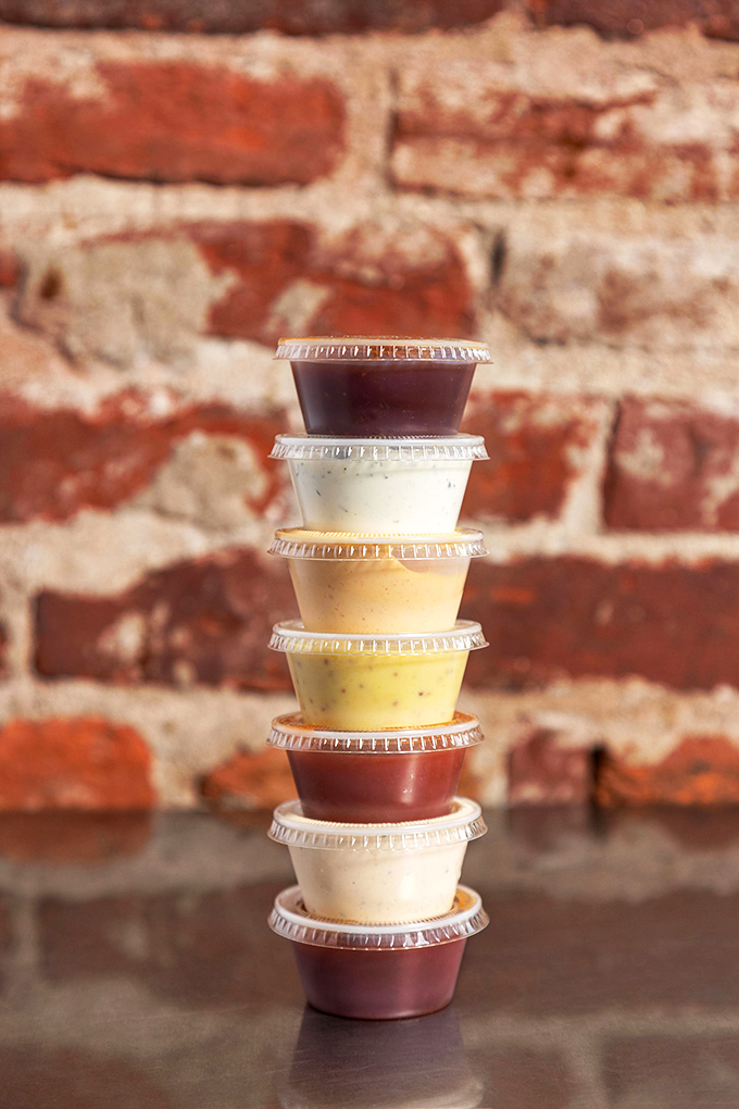A tower of house-made sauces stands ready for duty&mdash;each one a different personality waiting to complement your chicken in its own special way.