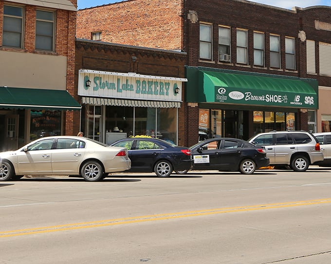 Storm Lake Bakery anchors the street like a carb-loaded lighthouse, guiding hungry souls to salvation.