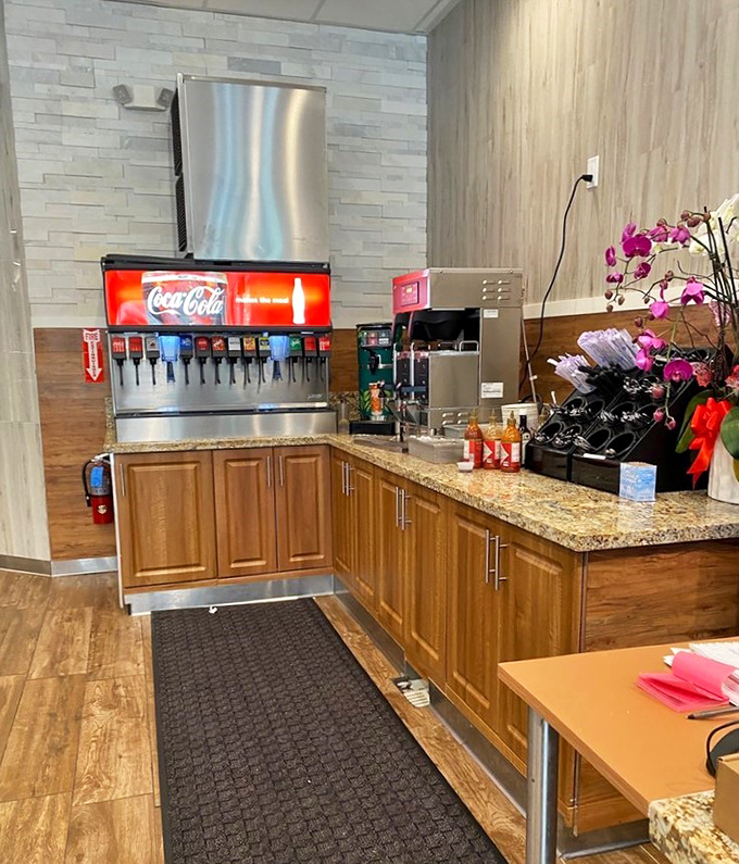 The beverage station &ndash; where unlimited refills meet unexpected elegance. That orchid isn't just decoration; it's a promise that this isn't your average buffet.