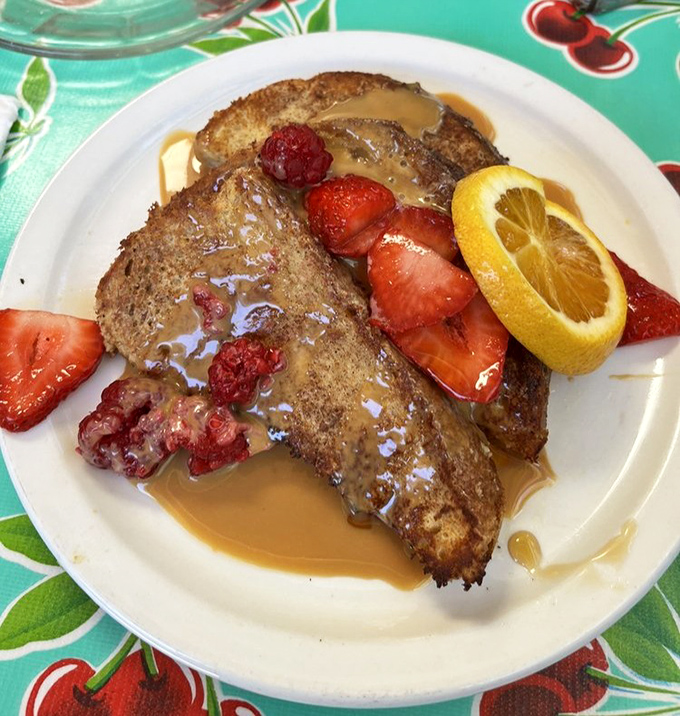 French toast that crossed the border into dessert territory and decided to stay, bringing along strawberries and maple for the journey.