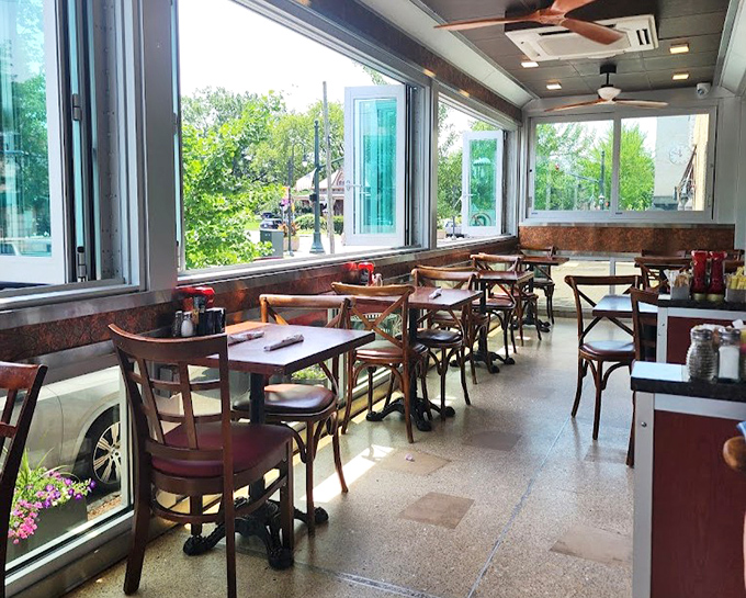 The sunlit dining area offers prime people-watching with a side of "yes, we can all see you taking pictures of your breakfast."