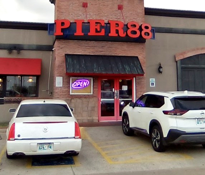 The bright red door welcomes hungry visitors, promising seafood salvation just steps away from the parking lot.