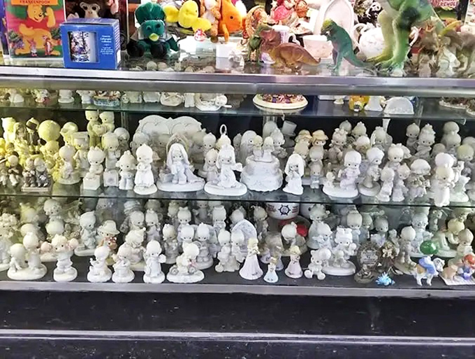 Precious Moments figurines stand in formation like a porcelain army of sweetness. Grandma's collection has nothing on this display of wide-eyed innocence.