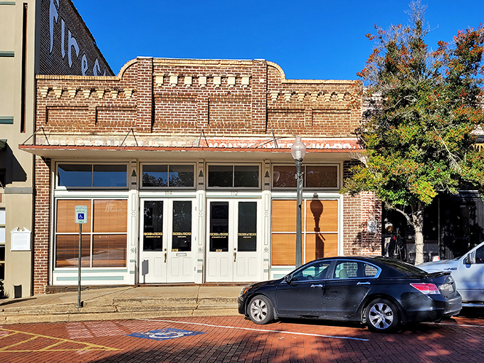 Elegant architectural details crown this historic downtown building. The ornate brickwork and grand windows speak to a time when craftsmanship mattered above all.