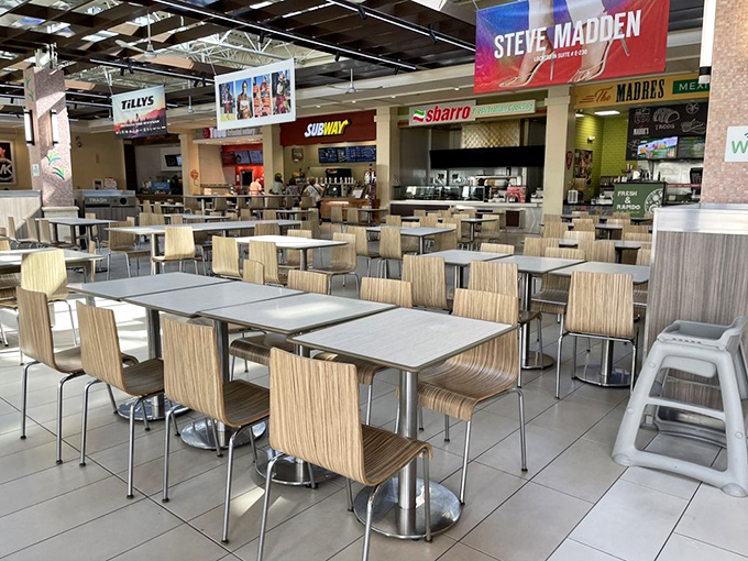 The food court: retail therapy's refueling station. Where hungry shoppers gather to strategize their next bargain hunting expedition over quick bites.