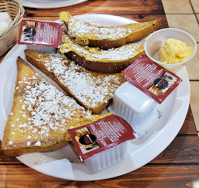 French toast dusted with powdered sugar and served with real butter&mdash;breakfast's answer to dessert. The packets of syrup are just waiting to complete this sweet symphony. 