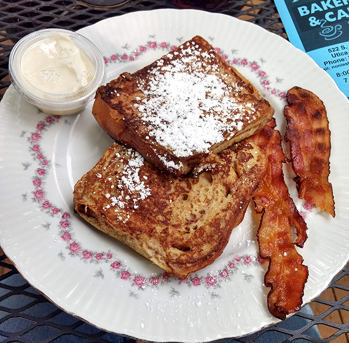 French toast that's achieved the perfect golden-brown exterior while maintaining custardy softness inside. The powdered sugar is just showing off.