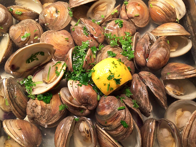 Clams having the world's most delicious garden party, with fresh herbs and lemon playing the perfect plus-one.