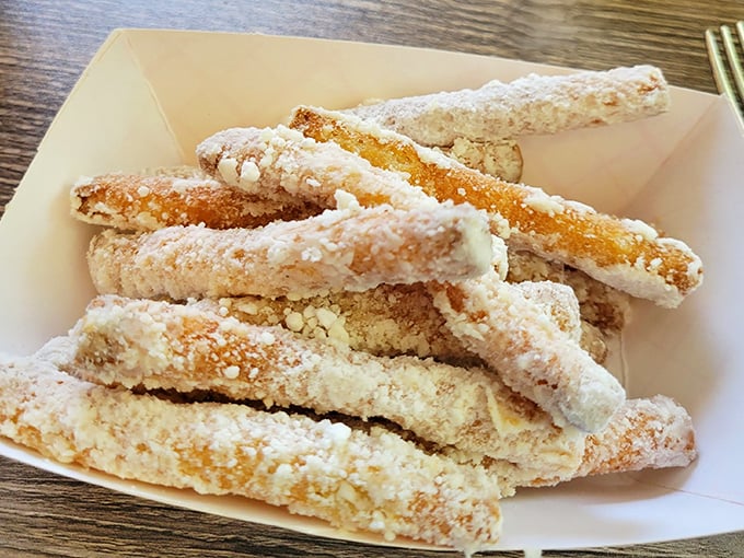 Funnel cake fries&mdash;because someone brilliant realized carnival joy shouldn't be limited to annual events. That powdered sugar dusting is pure nostalgia.