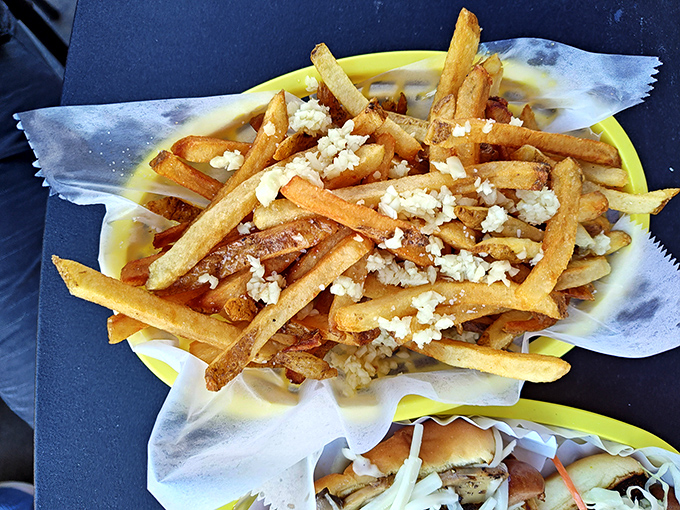 Garlic fries that don't whisper, they announce themselves with authority. The perfect shareable that nobody actually wants to share.