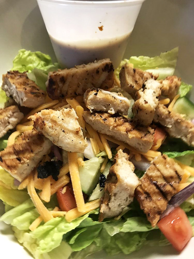 This isn't just a chicken salad; it's a protein-packed garden party where grilled poultry plays host to a colorful vegetable gathering.