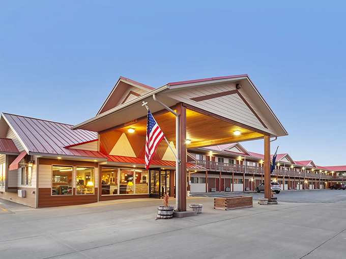 Harmony Inn & Suites glows with warm light at dusk, promising weary travelers the two things they want most: comfort and no surprises.