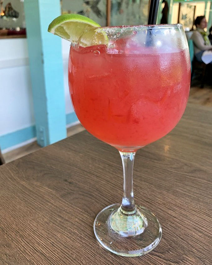 This hibiscus margarita isn't just a pretty face&mdash;it's a vacation in a glass, rimmed with promises of coastal relaxation.