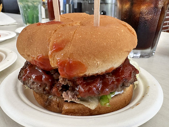The legendary Hickoryburger arrives with its signature sauce cascading down the sides—a messy masterpiece worth every napkin you'll need.